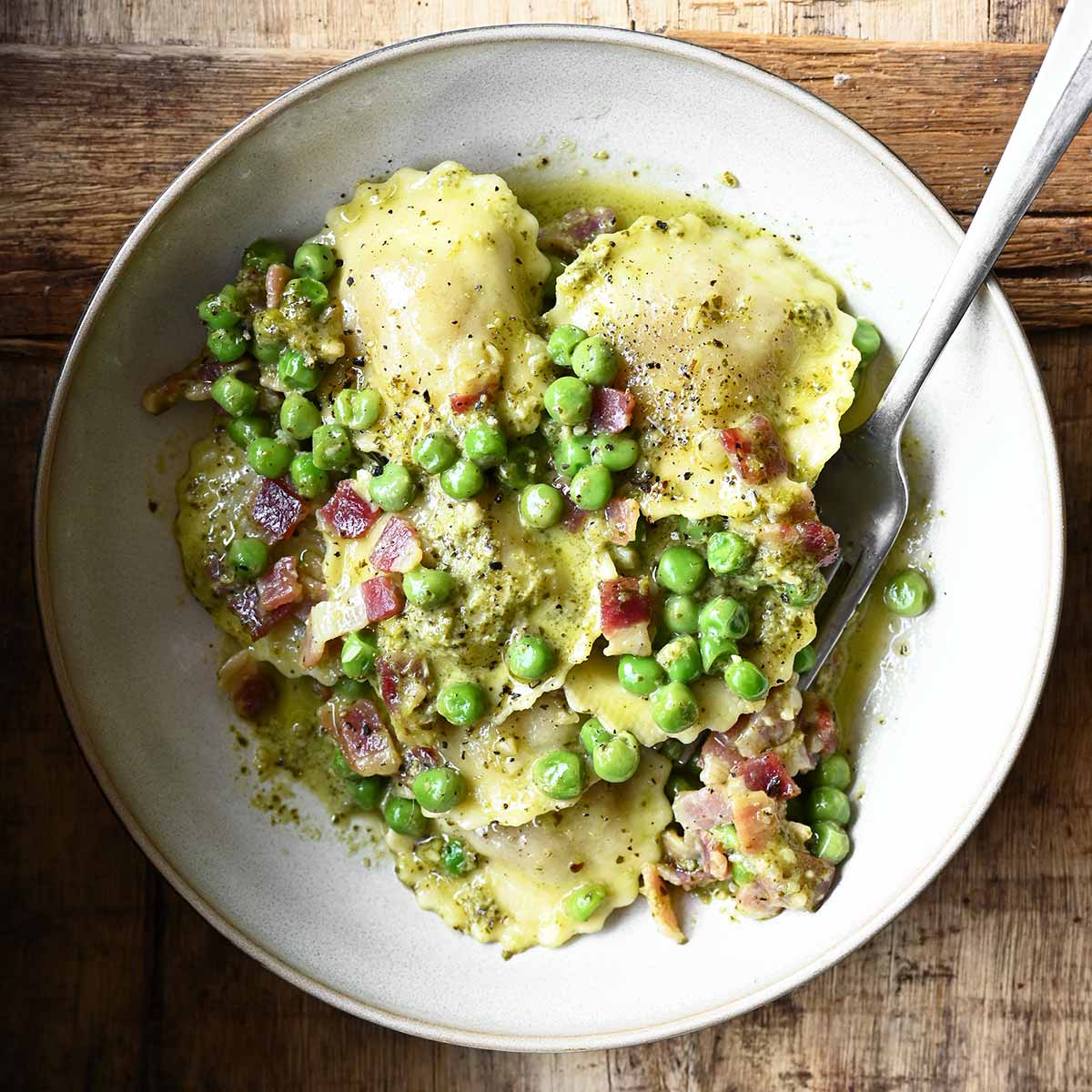 Pesto Ravioli with Pancetta and Peas - Serving Dumplings